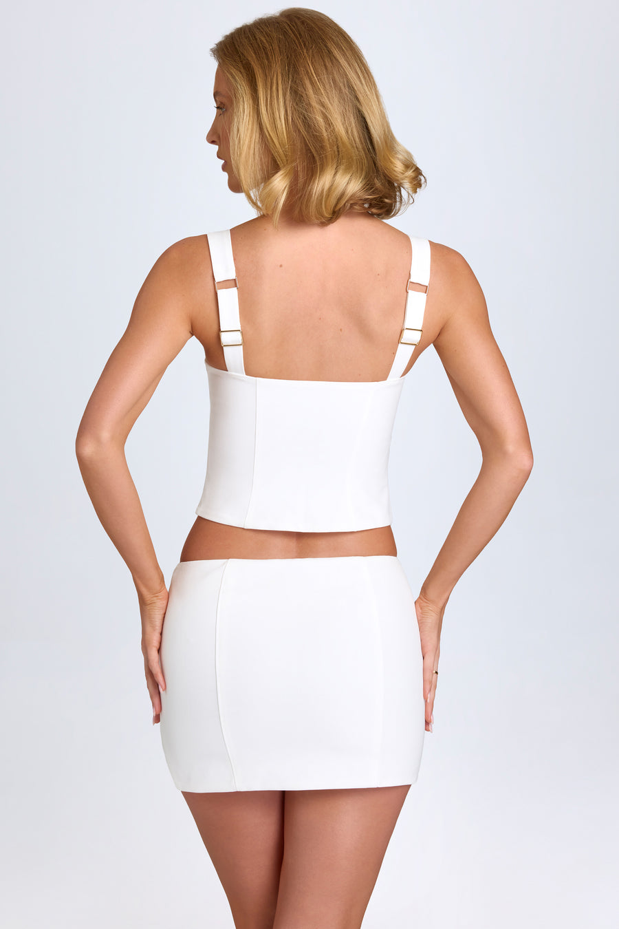 Issa Curved Low-Rise Mini Skirt in White | Oh Polly