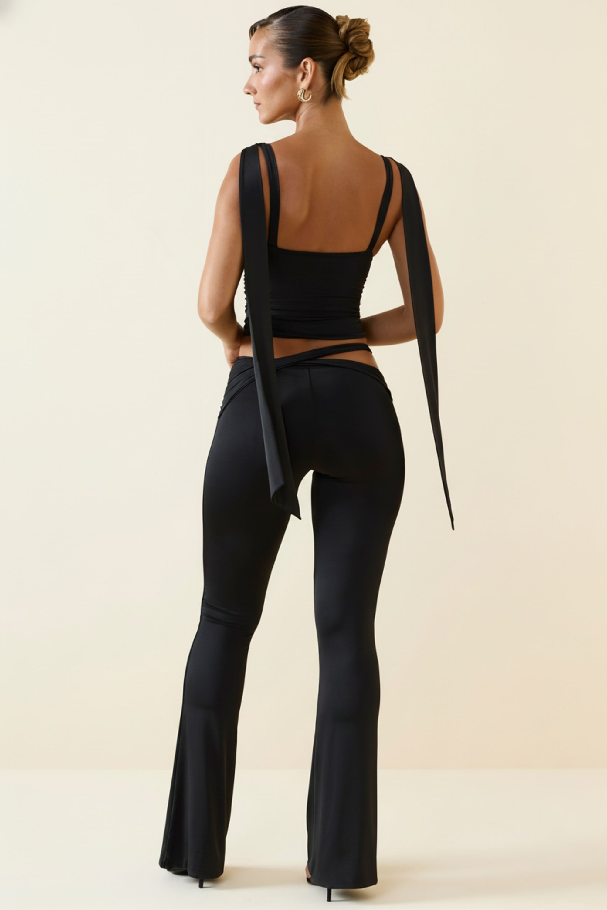 Shadi Cut-Out Mid-Rise Flared Trousers in Black | Oh Polly